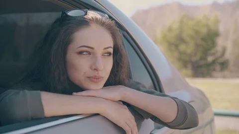 lady leans out of car window and looks a... | Stock Video | Pond5