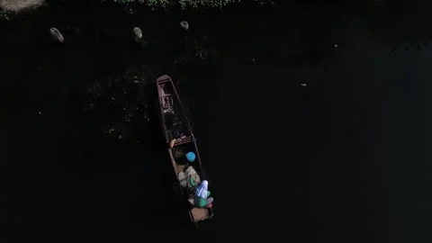 Lake boatman maneuvers his wooden row fi... | Stock Video | Pond5