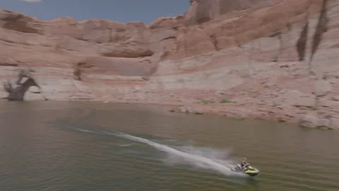 Lake Powell woman rides wave runner thro... | Stock Video | Pond5