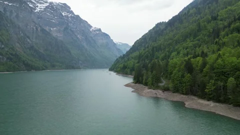 Lake stream with mountains and road runn... | Stock Video | Pond5
