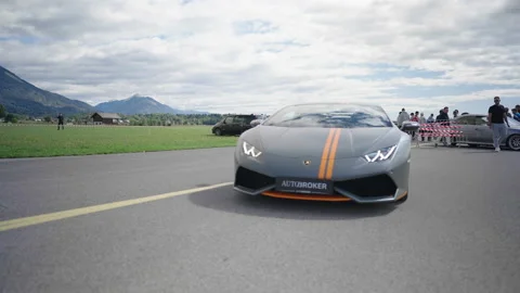 Lamborghini supercar driving slow on tra... | Stock Video | Pond5
