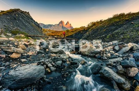 Landscape of iconic three peak and waterfall flowing of Aiguilles ...