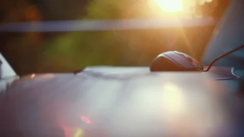 Laptop and mouse an outdoors at sunset w... | Stock Video | Pond5