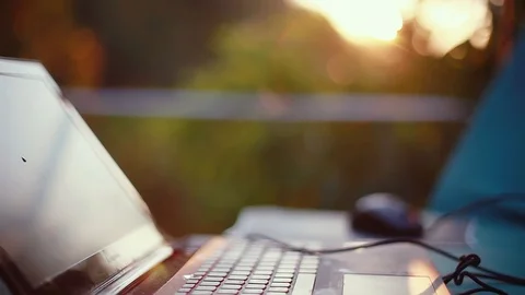 Laptop and mouse an outdoors at sunset w... | Stock Video | Pond5