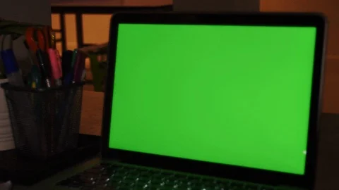 Laptop with green screen. Dark home offi... | Stock Video | Pond5
