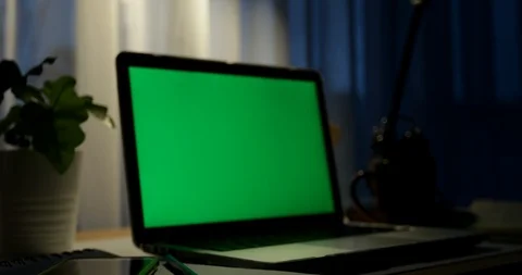 Laptop with green screen. Dark office. D... | Stock Video | Pond5