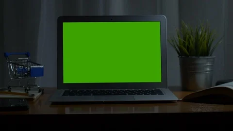 Laptop with green screen. Dark office. D... | Stock Video | Pond5