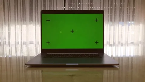 Laptop with the green screen on the tabl... | Stock Video | Pond5