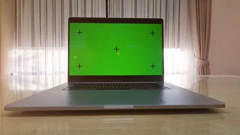 Laptop with the green screen on the tabl... | Stock Video | Pond5