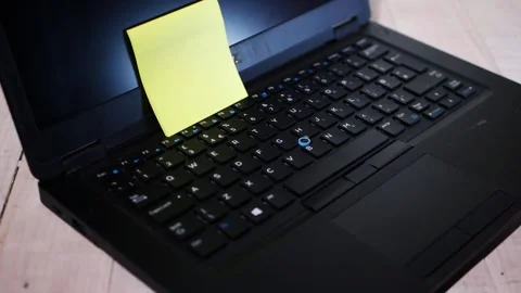 Laptop with sticking note on a desk | Stock Video | Pond5