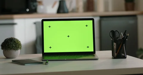 A laptop on table with green screen on b... | Stock Video | Pond5