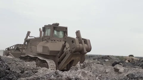 Large bulldozer bucket in a waste slag p... | Stock Video | Pond5