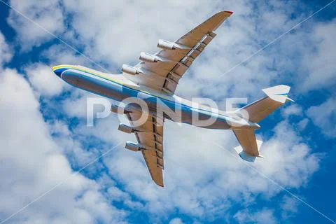 Photograph: A large cargo plane flies in the blue sky. Aviation air ...