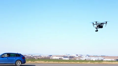 A large Drone Following a Car Filming - ... | Stock Video | Pond5