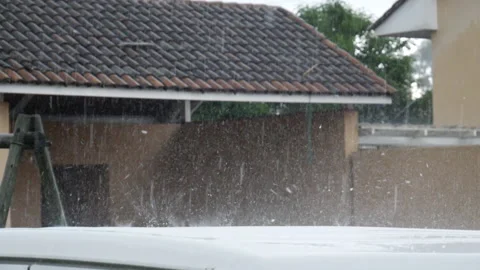 Large hail stones bouncing off a car roo... | Stock Video | Pond5