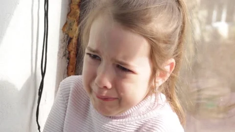 a large portrait of a little crying girl... | Stock Video | Pond5