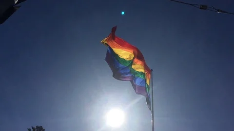 Large rainbow flag waving high atop of f... | Stock Video | Pond5
