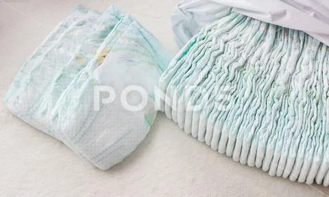 A large stack of baby diapers, close-ups, diaper packaging ~ Premium ...
