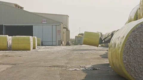Large tractor loading cotton bales at a ... | Stock Video | Pond5