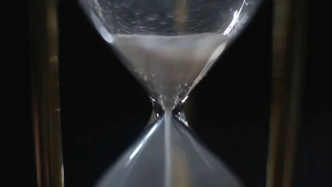 Last grains of sand falling in hourglass... | Stock Video | Pond5