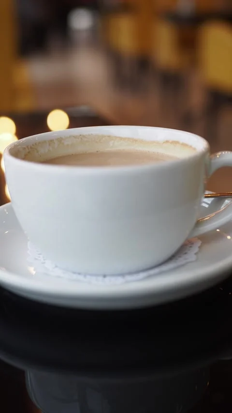 late coffee on cafe table at cafe backgr... | Stock Video | Pond5
