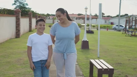 Latina mom walking in the park with her ... | Stock Video | Pond5