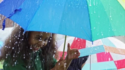 Laughing Little Girl Catching Raindrops | Stock Video | Pond5
