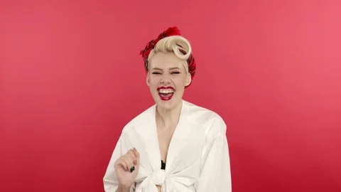 Laughing pin up girl showing thumbs up o... | Stock Video | Pond5