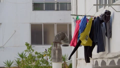 Laundry Drying in the Wind Against White... | Stock Video | Pond5