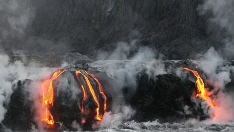 Lava flowing into the ocean from volcano... | Stock Video | Pond5