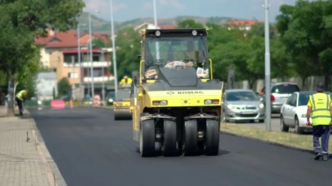 Laying new asphalt road pavement on a co... | Stock Video | Pond5