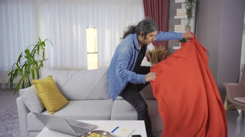 Lazy man inside the house is lying on th... | Stock Video | Pond5