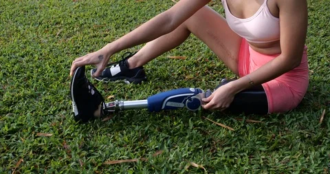 Leg Amputee asian girl doing leg stretch... | Stock Video | Pond5