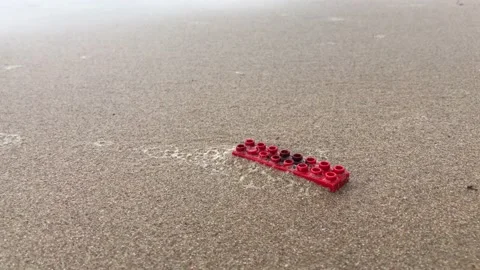 Lego piece plastic pollution at Beach Sa... | Stock Video | Pond5