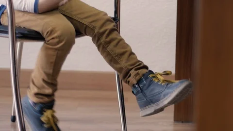 Legs of boy child moving while he is sit... | Stock Video | Pond5