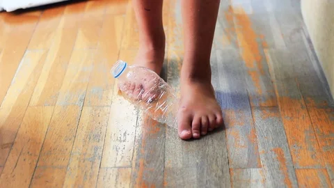 Legs of a child, barefoot, stepping on a... | Stock Video | Pond5