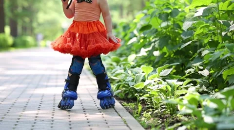 Legs of little girl in skirt roller-blad... | Stock Video | Pond5
