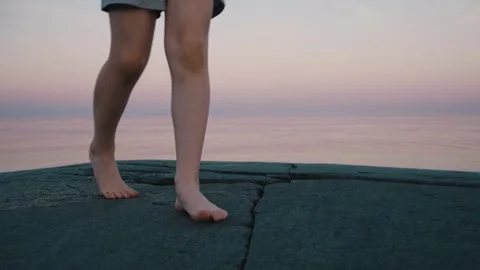 The legs of a little girl slowly walks a... | Stock Video | Pond5