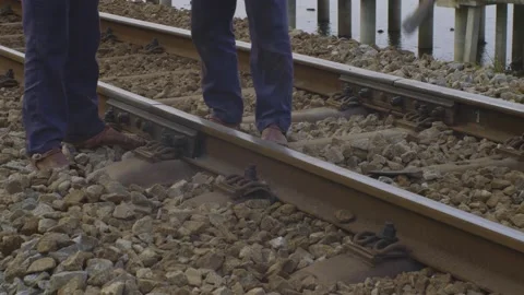 Legs of rail workers fastening tracks wi... | Stock Video | Pond5