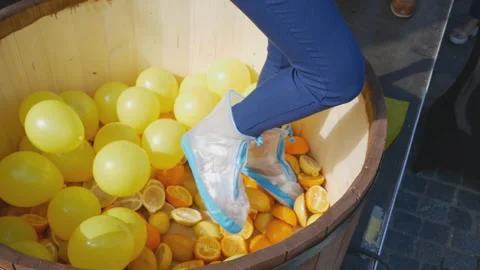 legs stomping citrus fruits into a woode... | Stock Video | Pond5