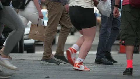 Legs/feet/cars compressed people running... | Stock Video | Pond5