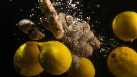 Lemon and ginger floating in water. Fres... | Stock Video | Pond5