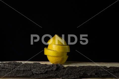 Lemon on a dark background. Sliced lemon on a black background. Stock ...