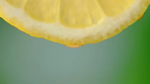 Lemon with dripping clear juice on green... | Stock Video | Pond5