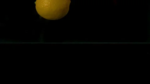 Lemon plunging into water on black backg... | Stock Video | Pond5