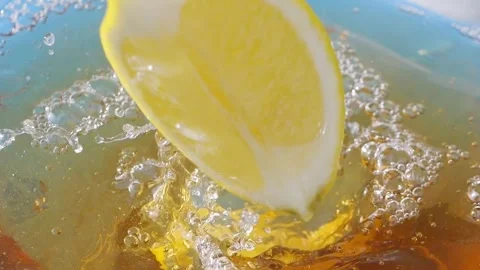 Lemon slices falling and splashing into ... | Stock Video | Pond5