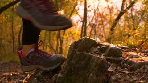 LENS FLARE: Hiker steps on rock while ex... | Stock Video | Pond5