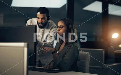Photograph: Lets troubleshoot some more. two call centre agents working ...