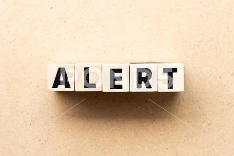 Letter block in word alert on wood background ~ Hi Res #116583758