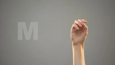 Letter M in sign language, hand on backg... | Stock Video | Pond5